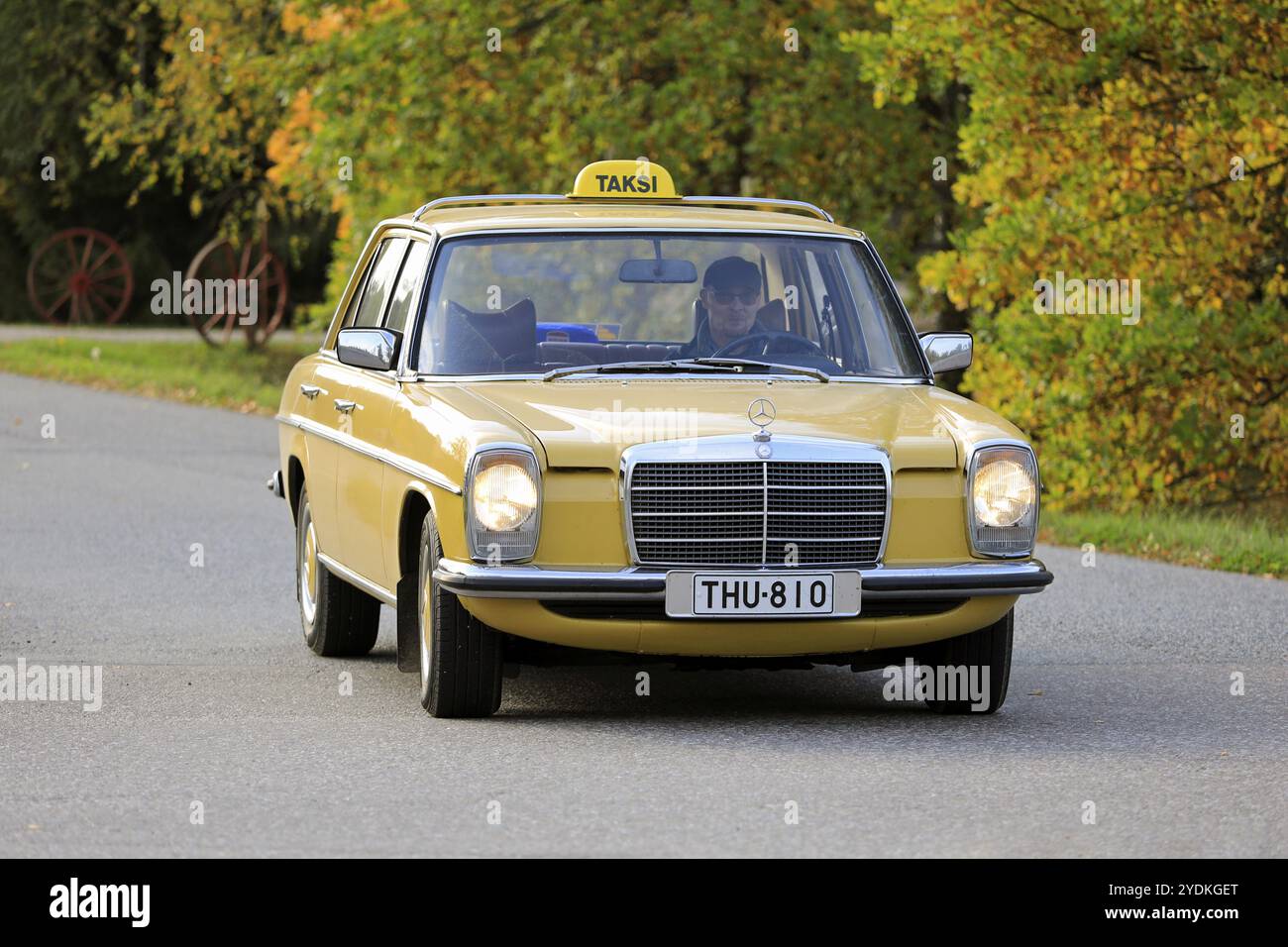 Yellow Taxi Mercedes-Benz W123 220D on small street. The W123, popular ...