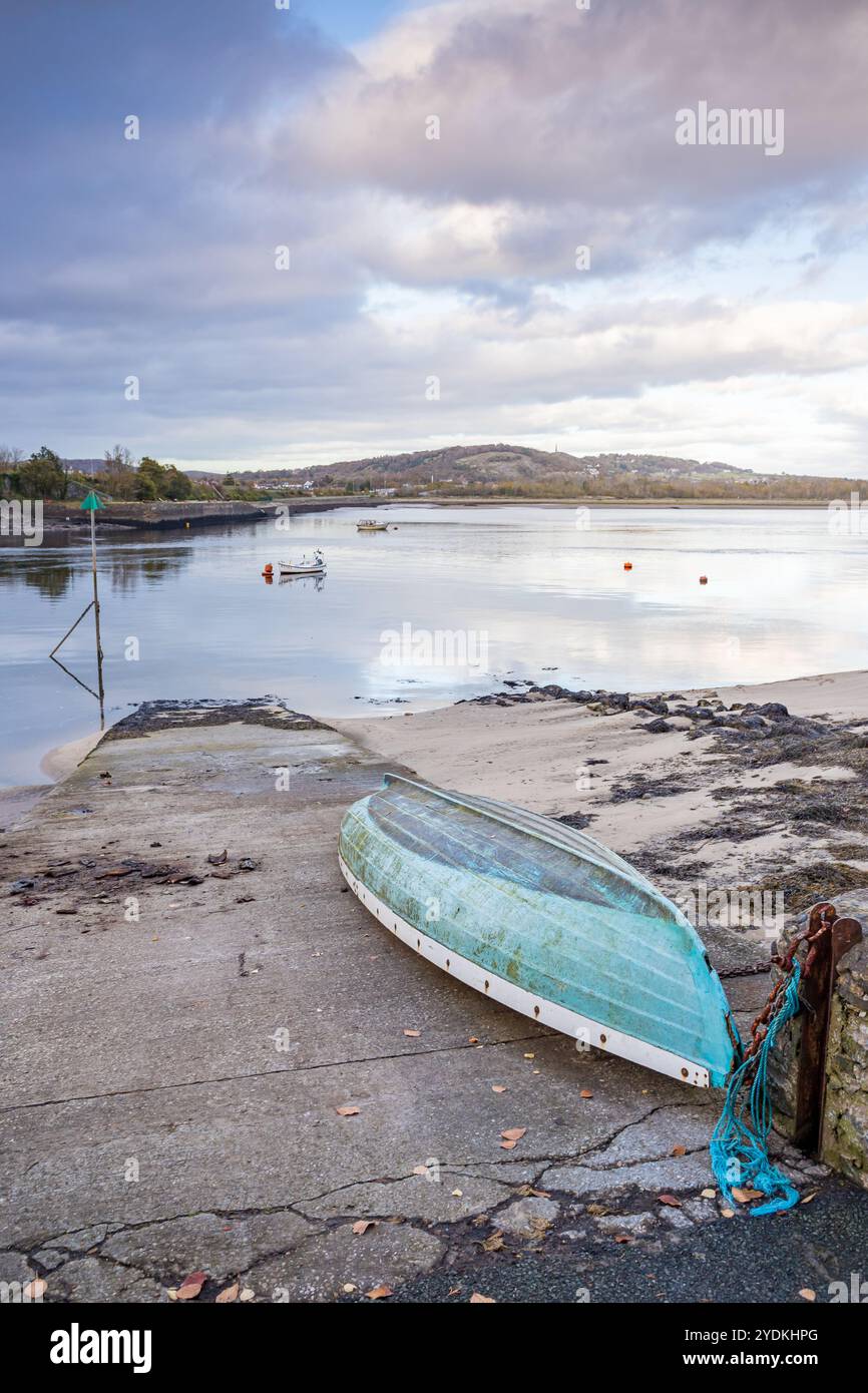 A small upturned boat pictured beside the River Conwy on a slipway in ...