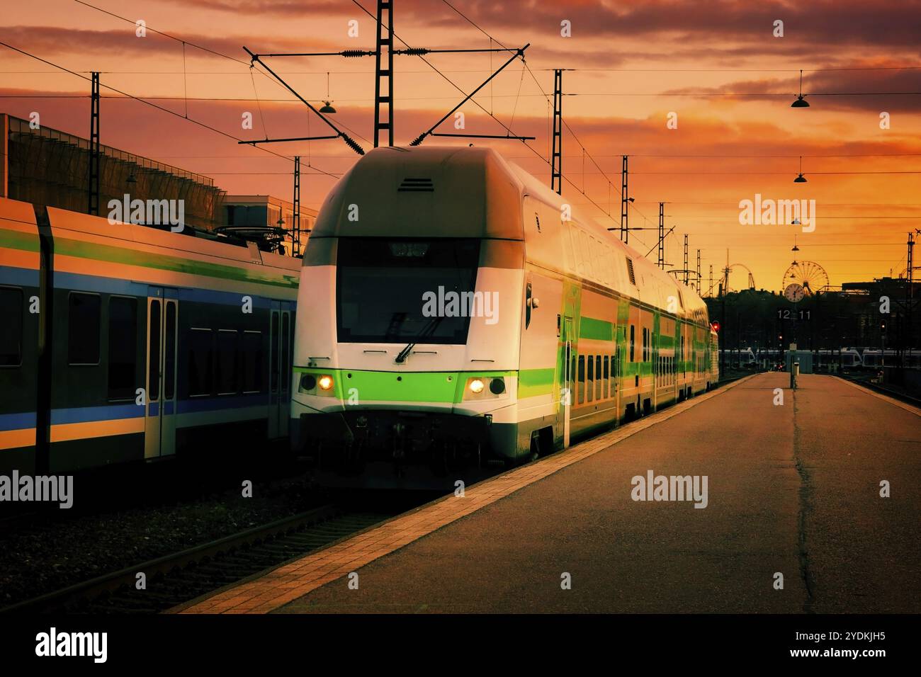 Modern electric 2 storey passenger train arrives at the platform of ...