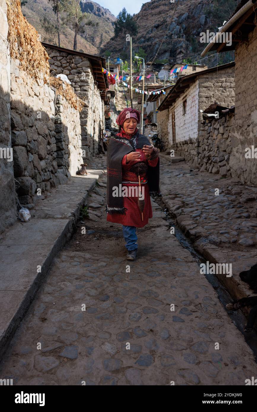 Peru - Tupe, October 23, 2022: A woman in traditional attire strolls ...