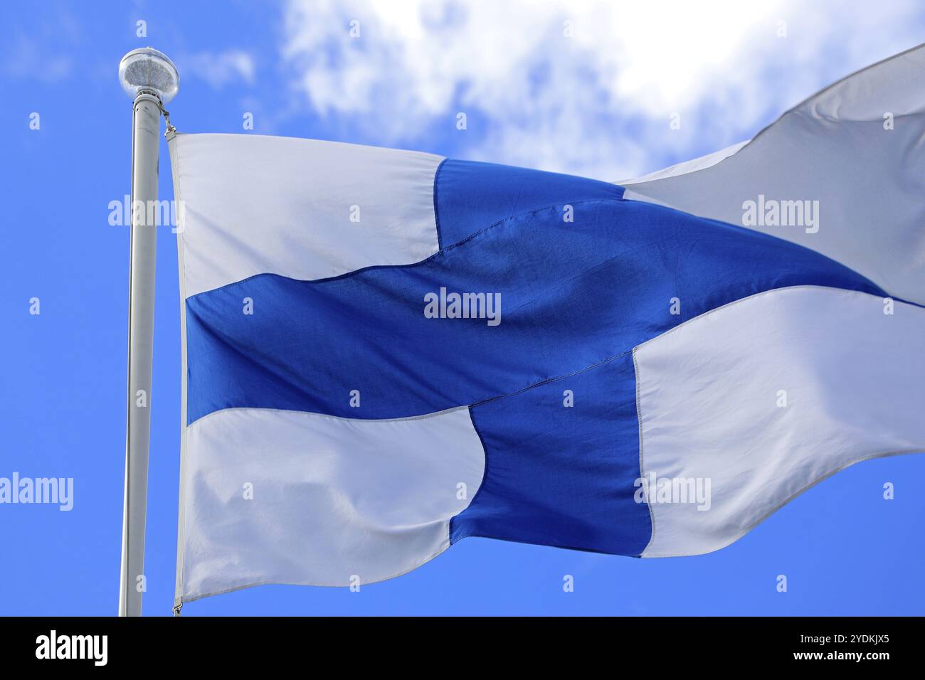 National Flag of Finland in motion flying against blue sky and white ...
