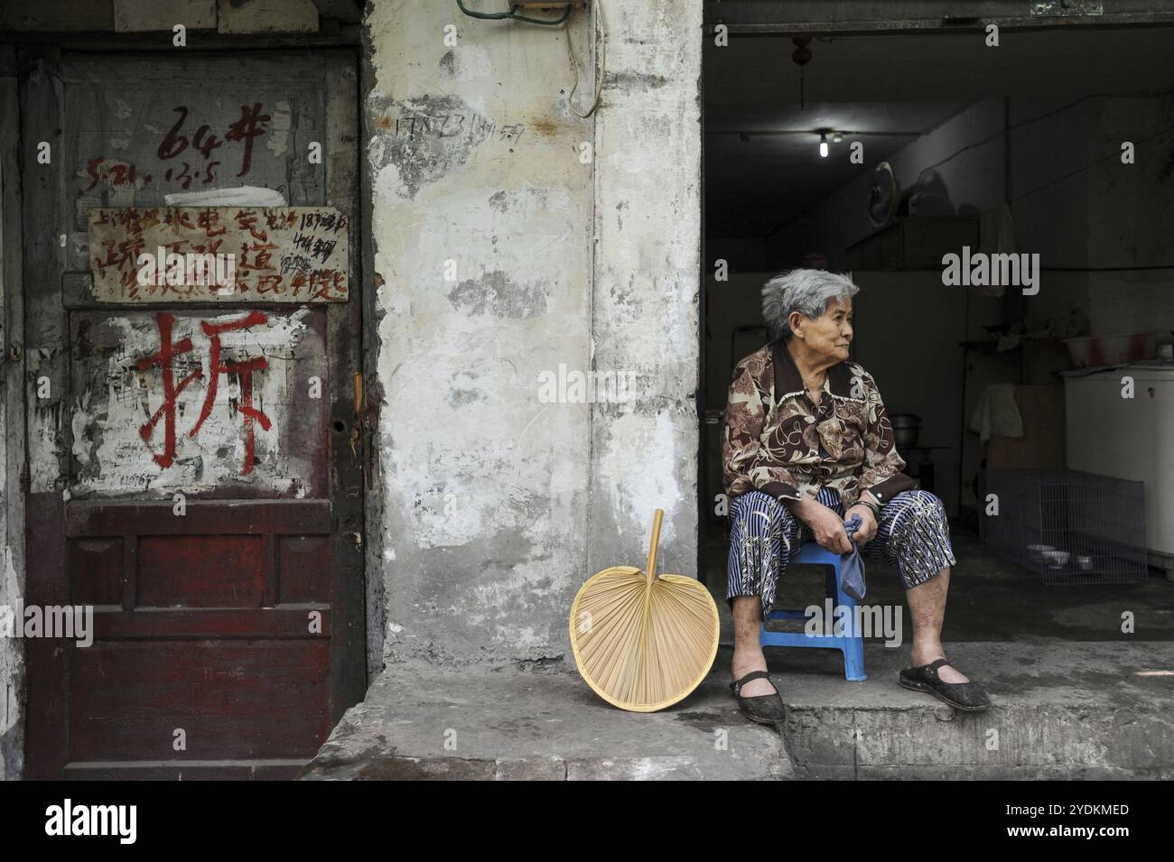 02.08.2012, Chongqing, China, Asia, An old woman sits on the steps ...