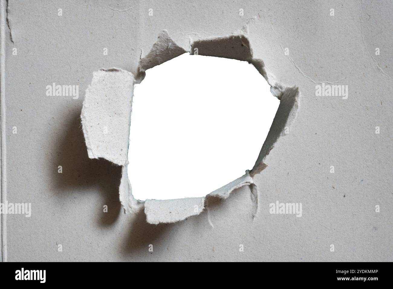 Gray paper with damaged hole in the center on white background with ...