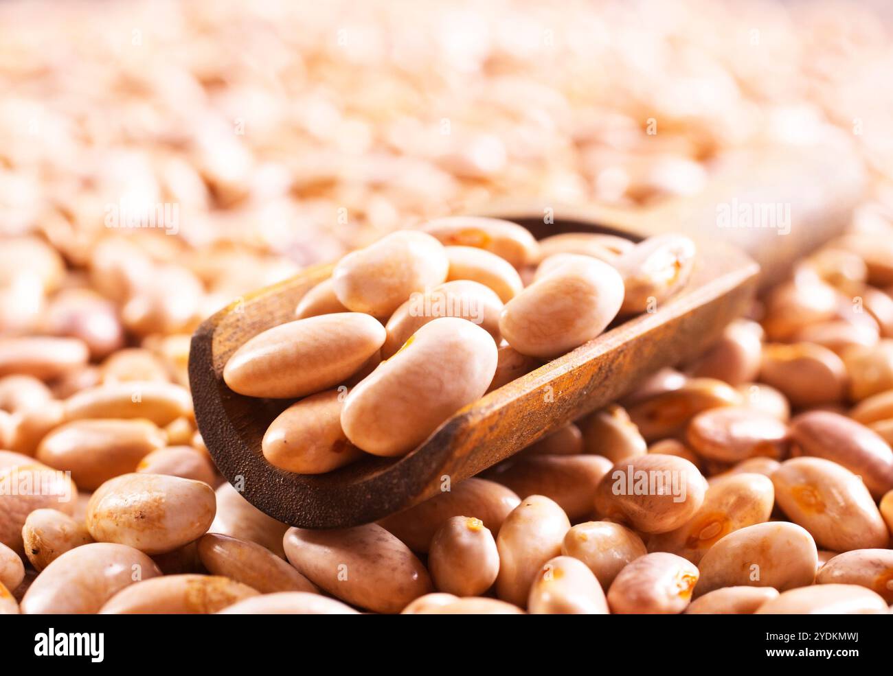 Beans and wooden spoon on a table Stock Photo - Alamy