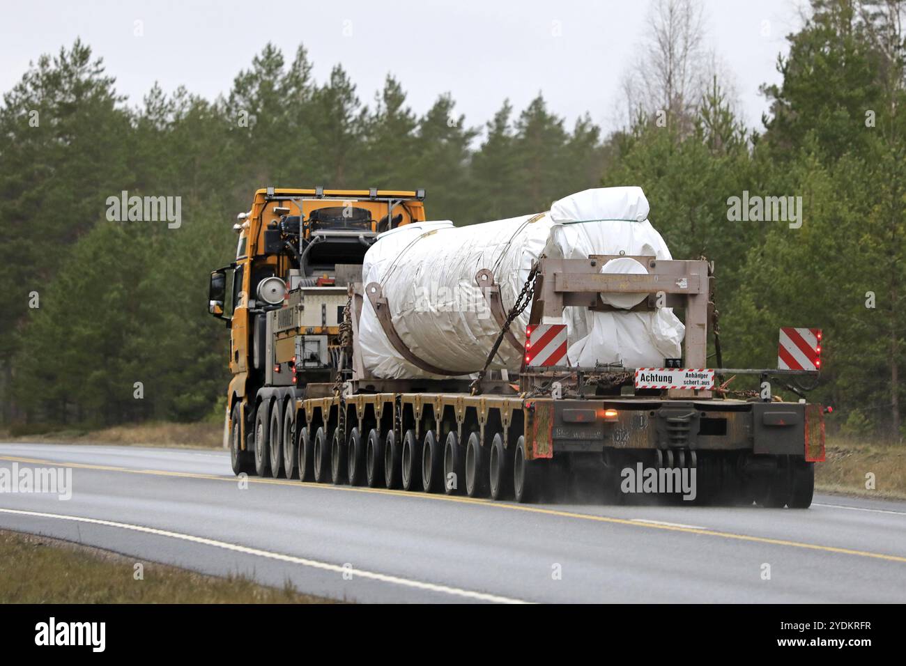 Yellow MAN TGX Bohnet GmbH semi multi axle low loader hauls industrial ...