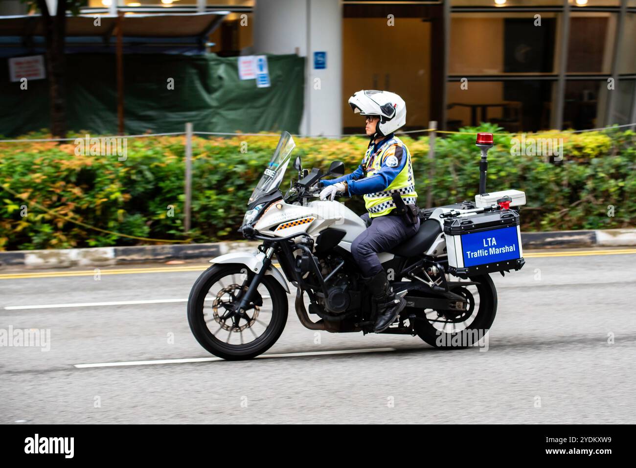 A Singapore Land Transport Authority (LTA) Traffic Marshall riding a ...