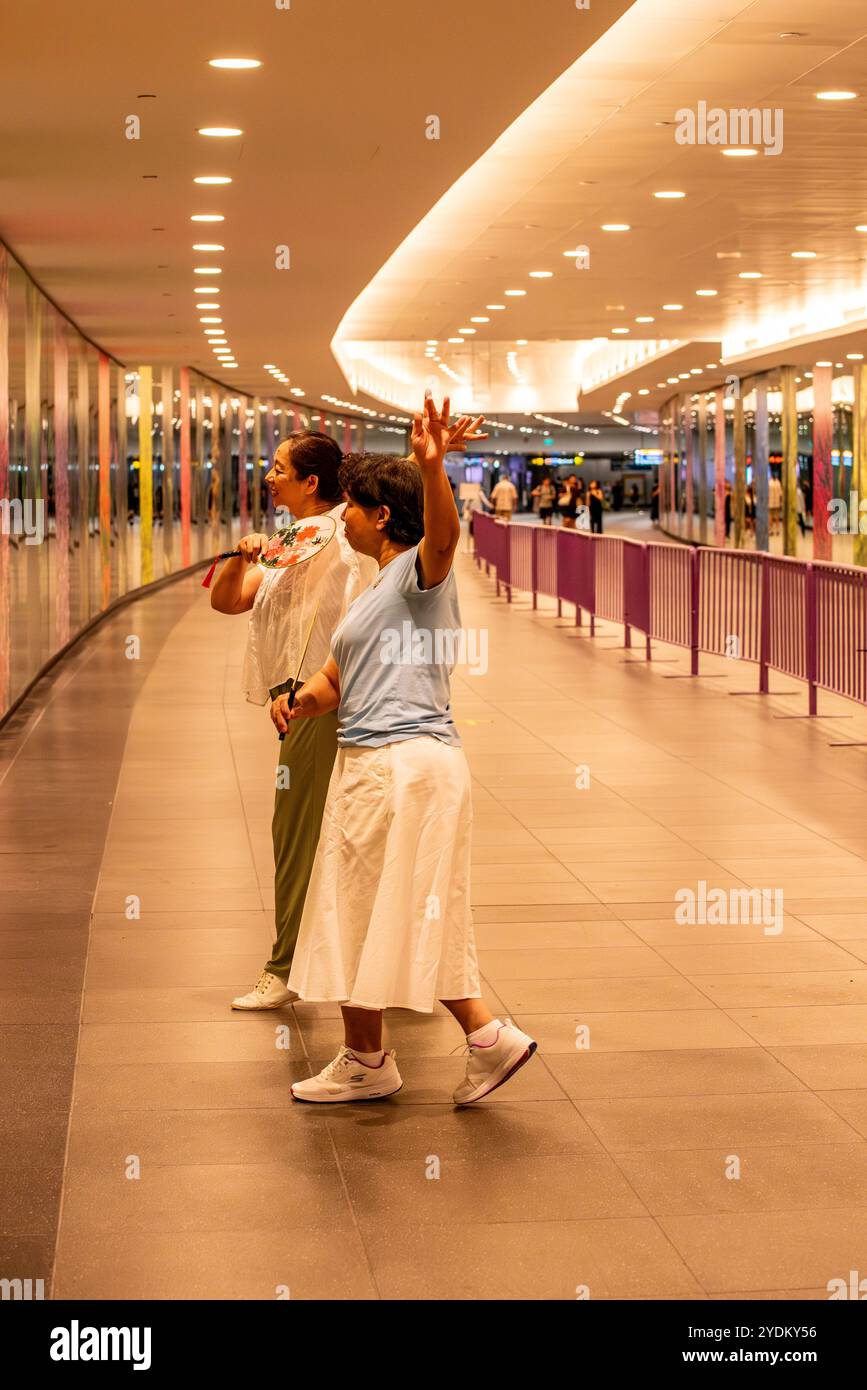 Two middle aged women practice their traditional Peranakan dance ...