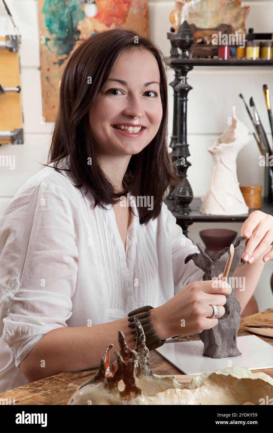 Artisan woman shaping clay sculpture in a studio Stock Photo - Alamy