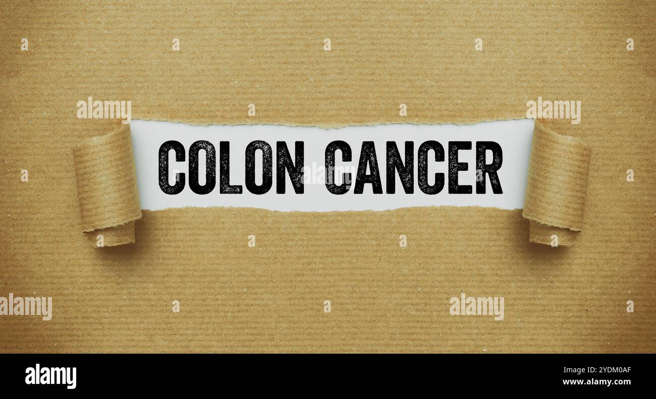 Torn paper revealing the word Colon cancer Stock Photo - Alamy