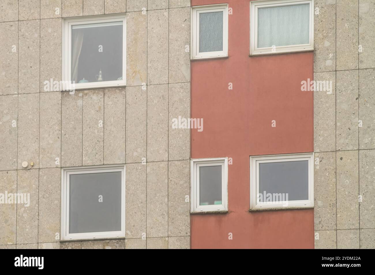 Geometric facade of a residential building featuring a mix of concrete ...