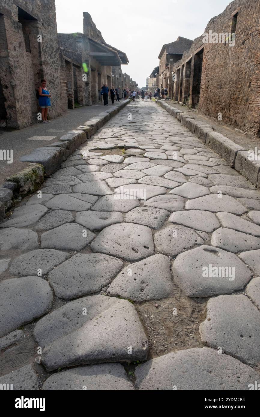 Narrow stone paved street in the Archaeological Park of Pompeii, Naples ...