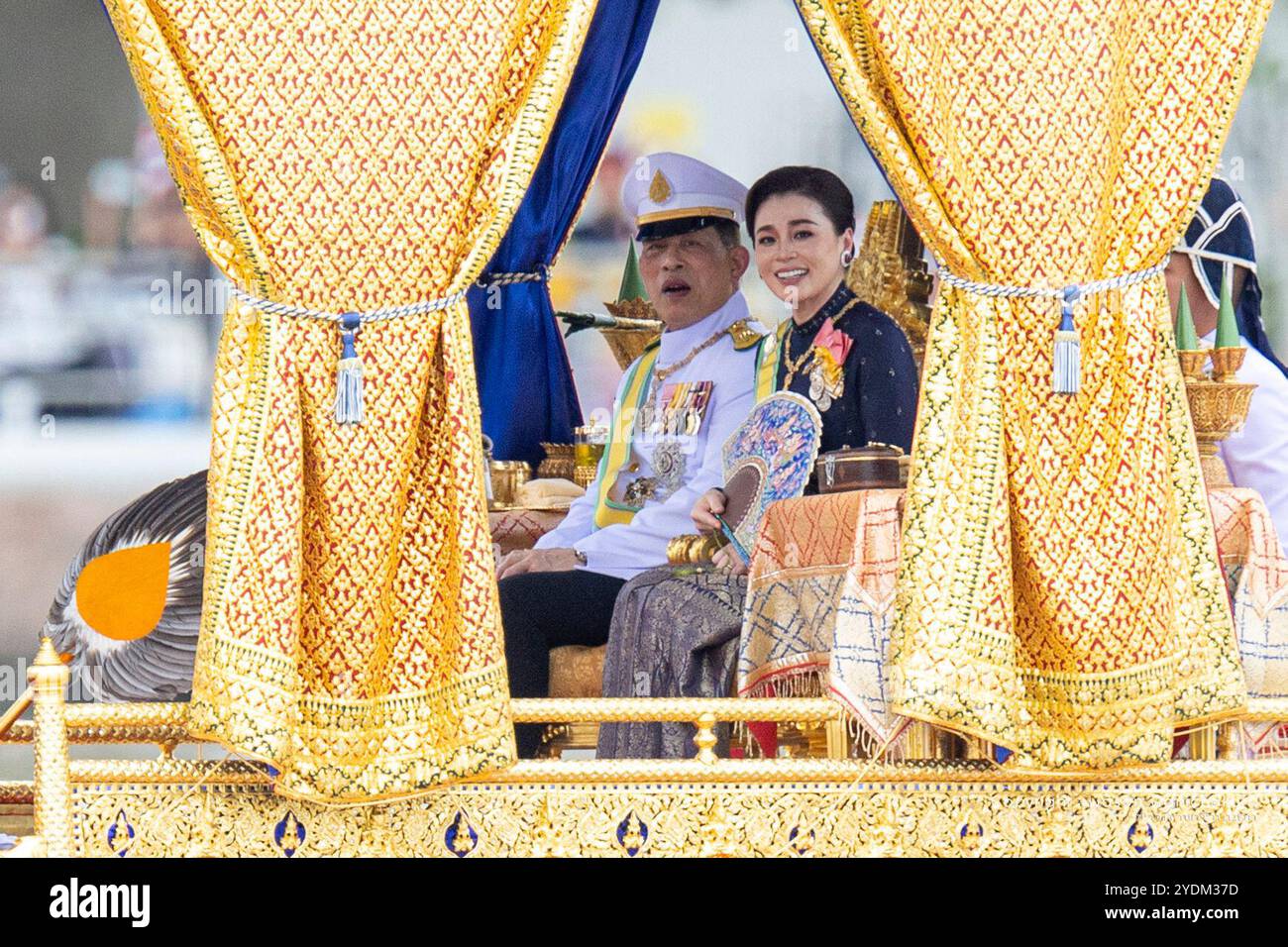 Oarsmen paddle the royal barge carrying King Maha Vajiralongkorn, left ...