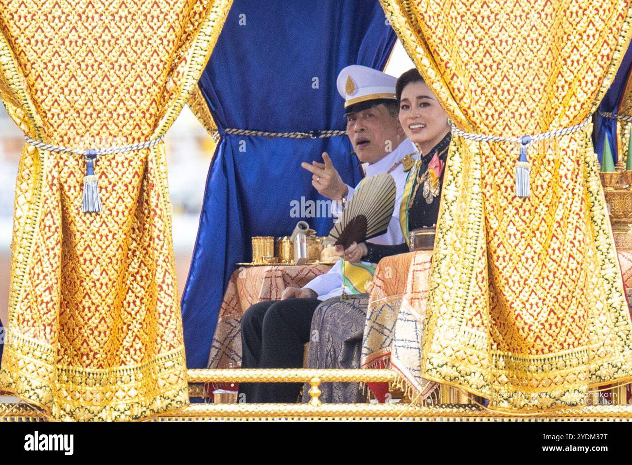 Oarsmen paddle the royal barge carrying King Maha Vajiralongkorn, left ...