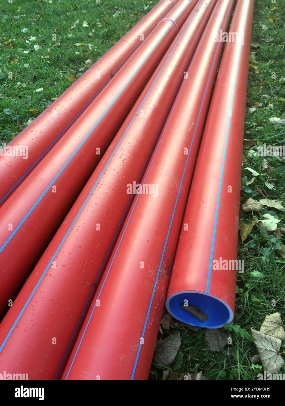 New five red pipes as shell for electric cables are ready for mounting ...