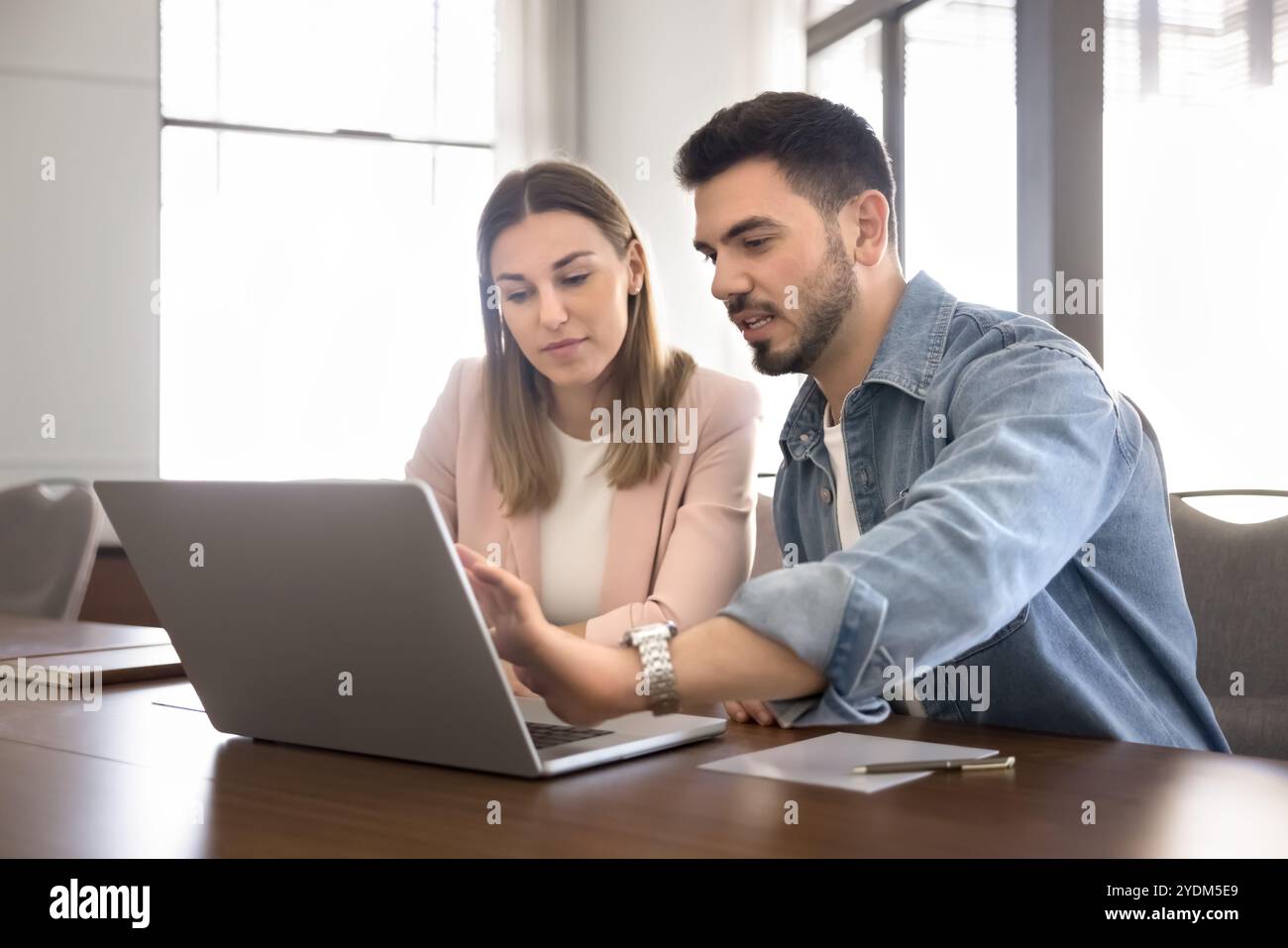 Employees pointing laptop screen hi-res stock photography and images ...