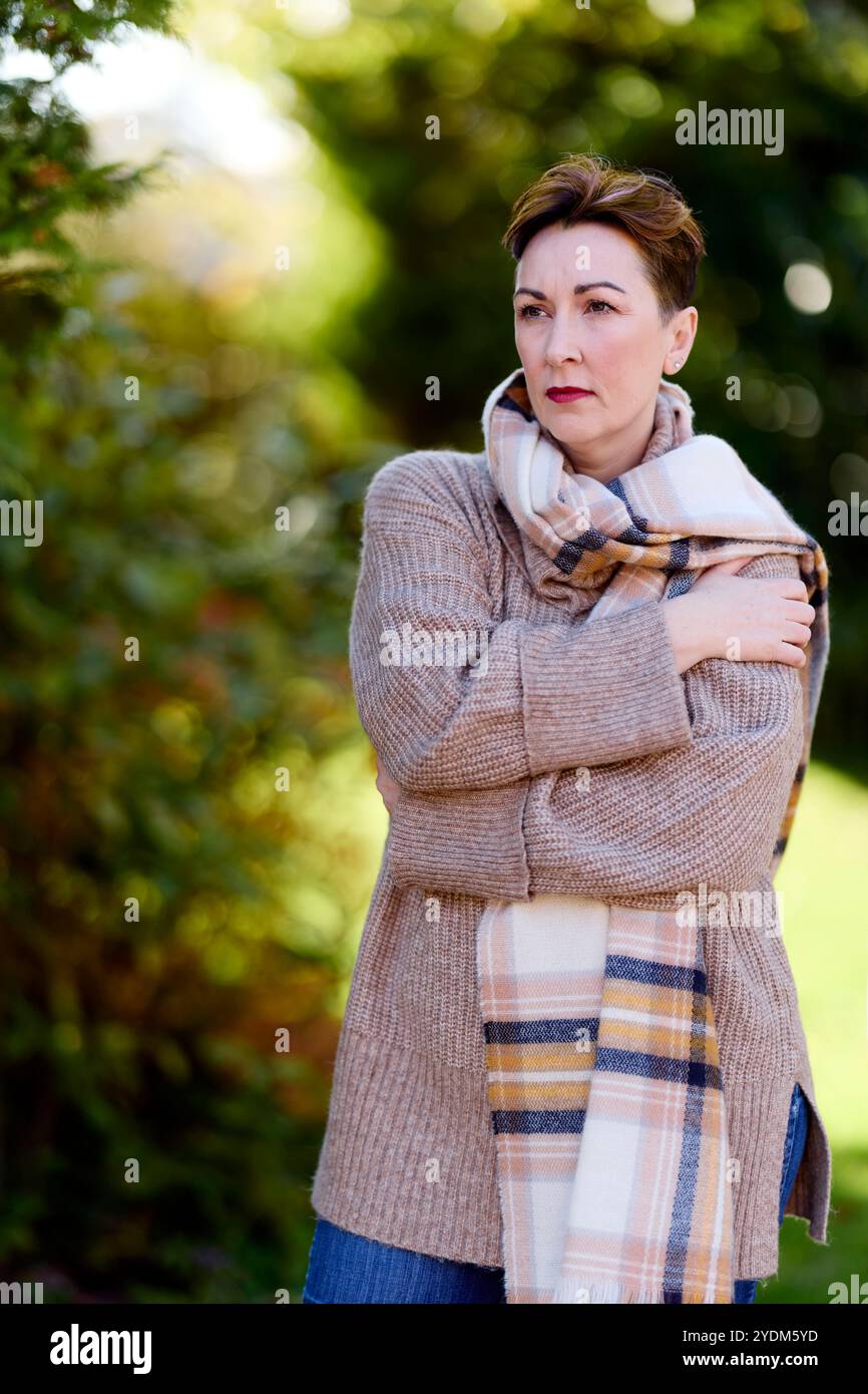 Woman looking concerned outdoors Stock Photo - Alamy