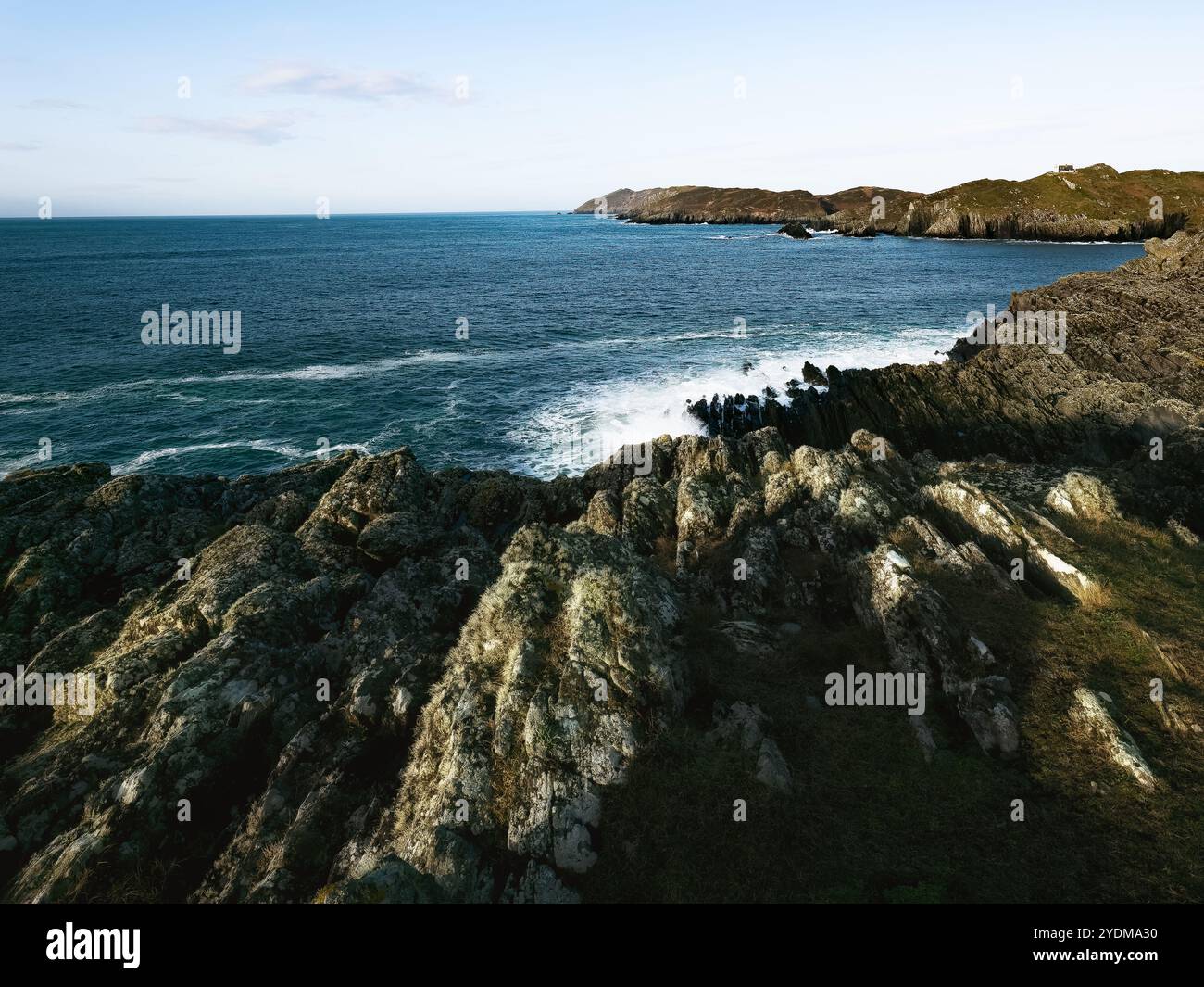 The stunning coastal view features rugged rock formations meeting the ...