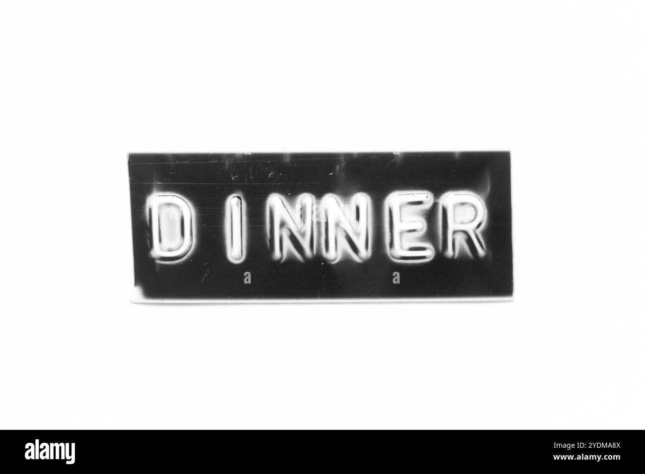 Black color banner that have embossed letter with word dinner on white ...