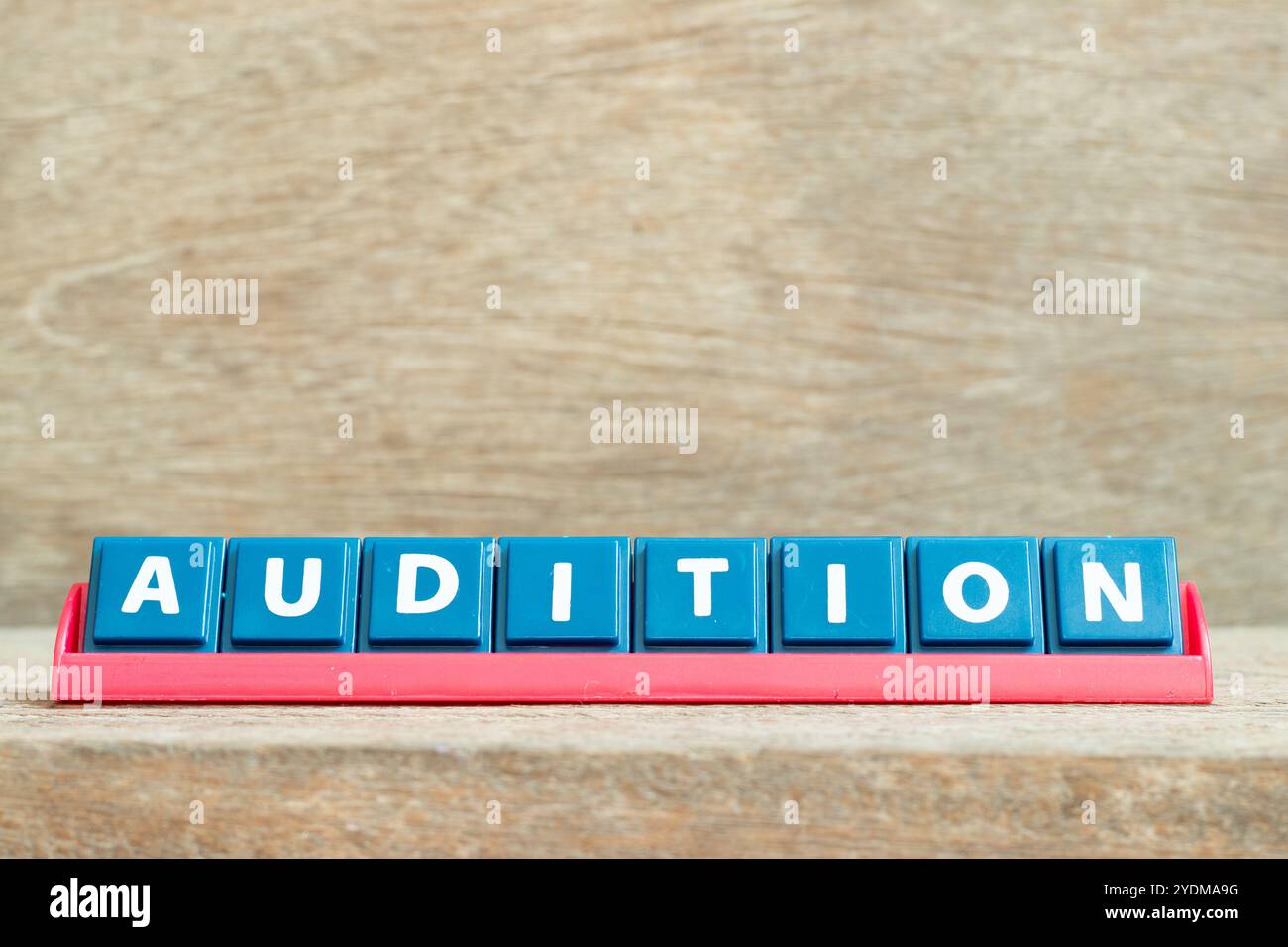 Tile alphabet letter with word audition in red color rack on wood ...