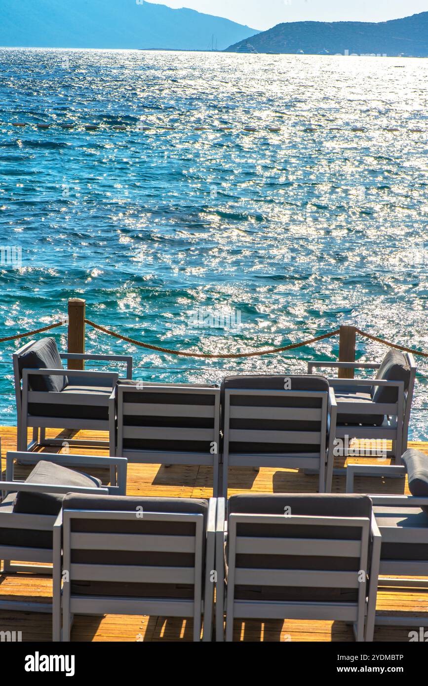 A picturesque scene of a chair positioned by the sea, inviting ...