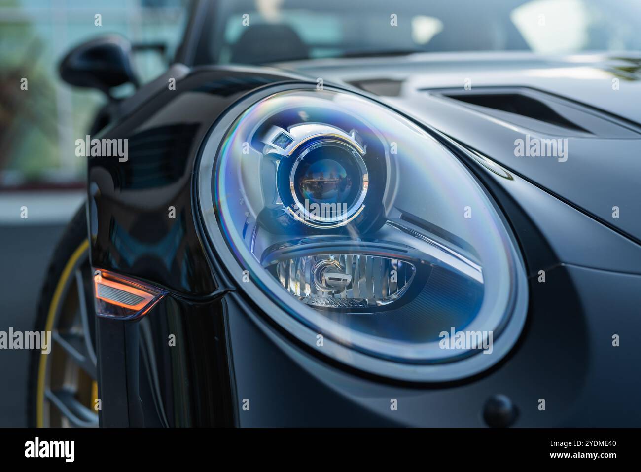 Luxury sports car headlight showcasing modern LED design and glossy ...