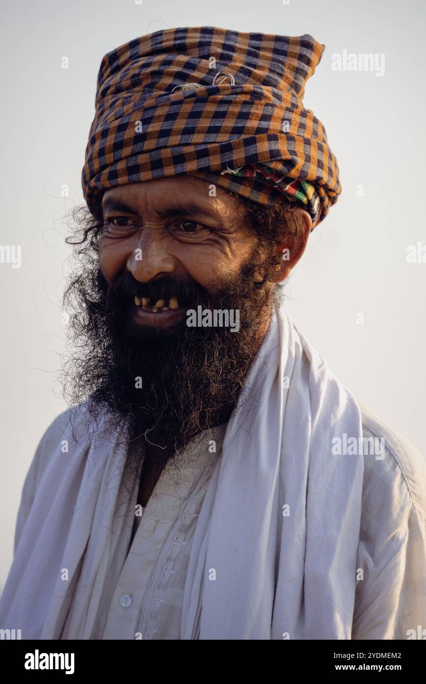 The smile of a happy man in Bangladesh. An old man on the river bank ...