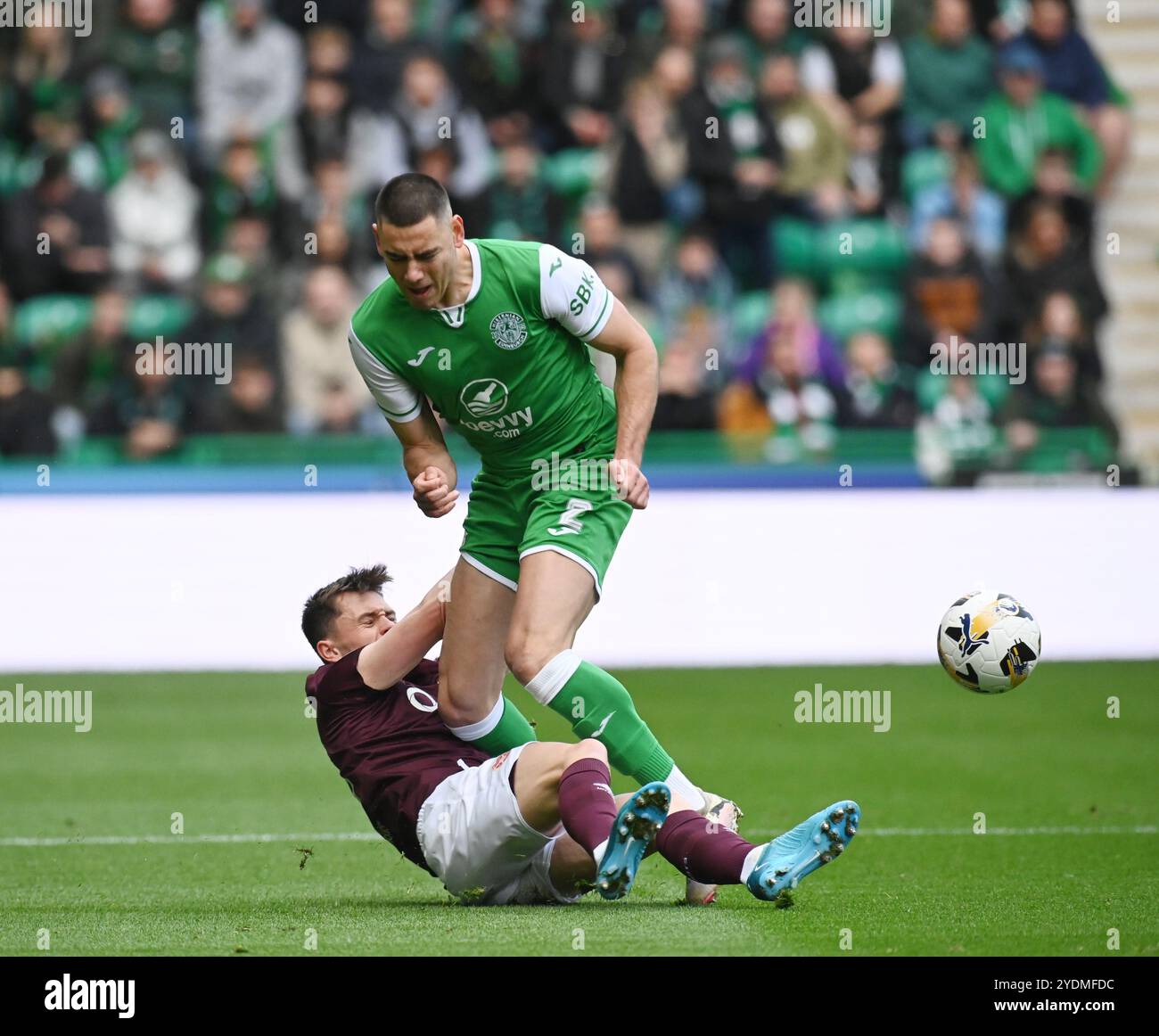 James penrice of hearts tackle on lewis miller hibs hi-res stock ...