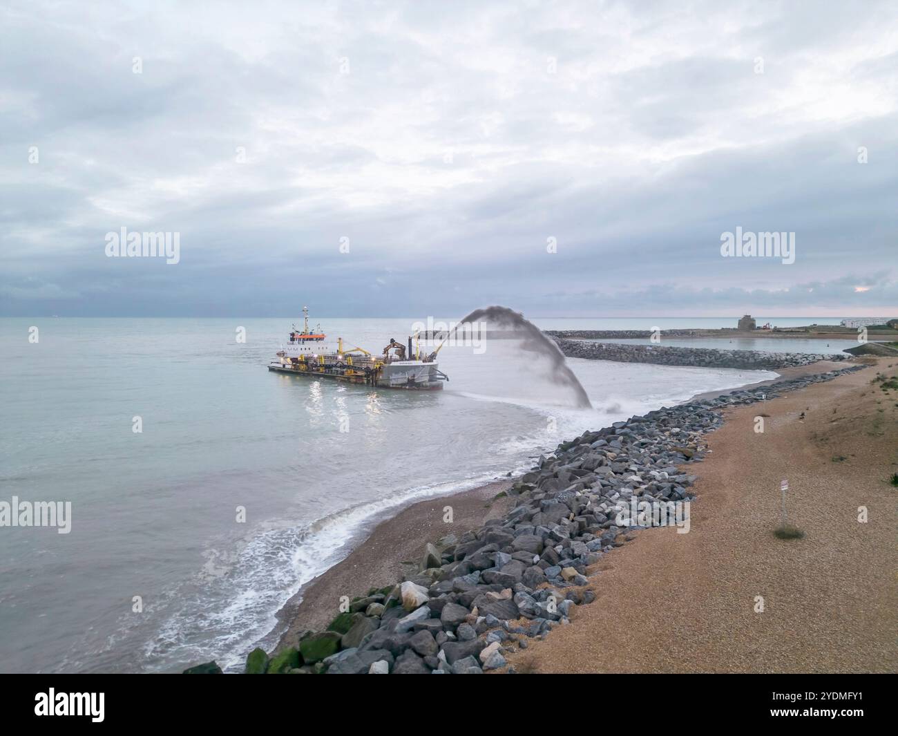 dredger barge spraying gravel on the beach at sovereign harbour ...