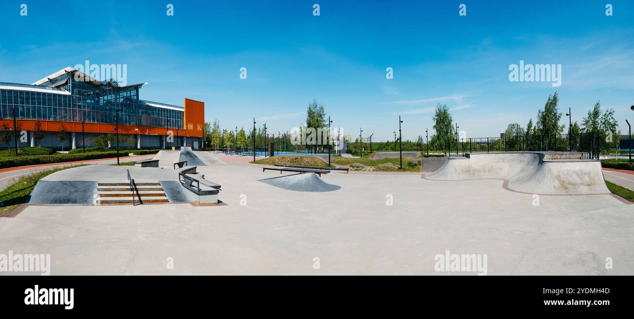 Panorama of empty public skateboard ramp park made of cement. Outdoors ...