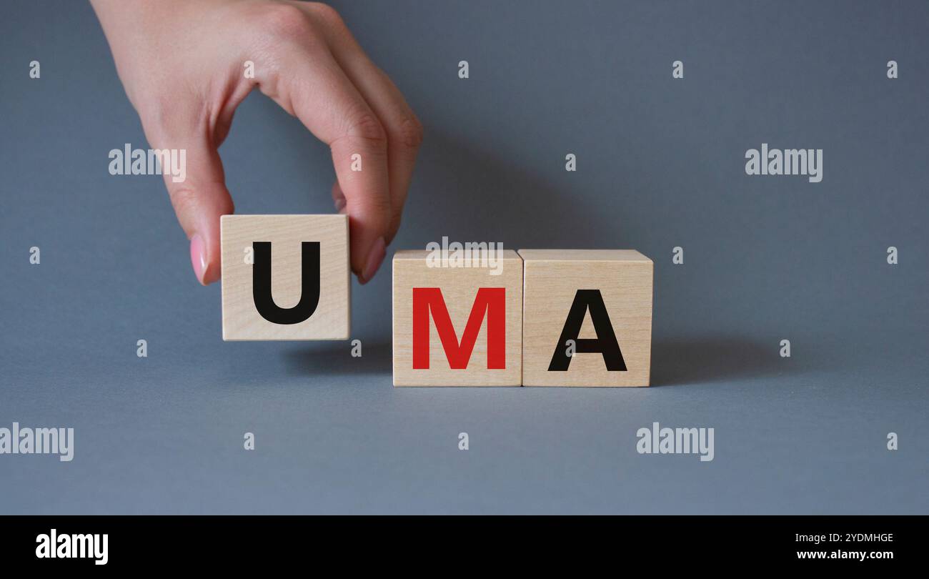 UMA - Unified Managed Account. Wooden cubes with word UMA. Businessman ...
