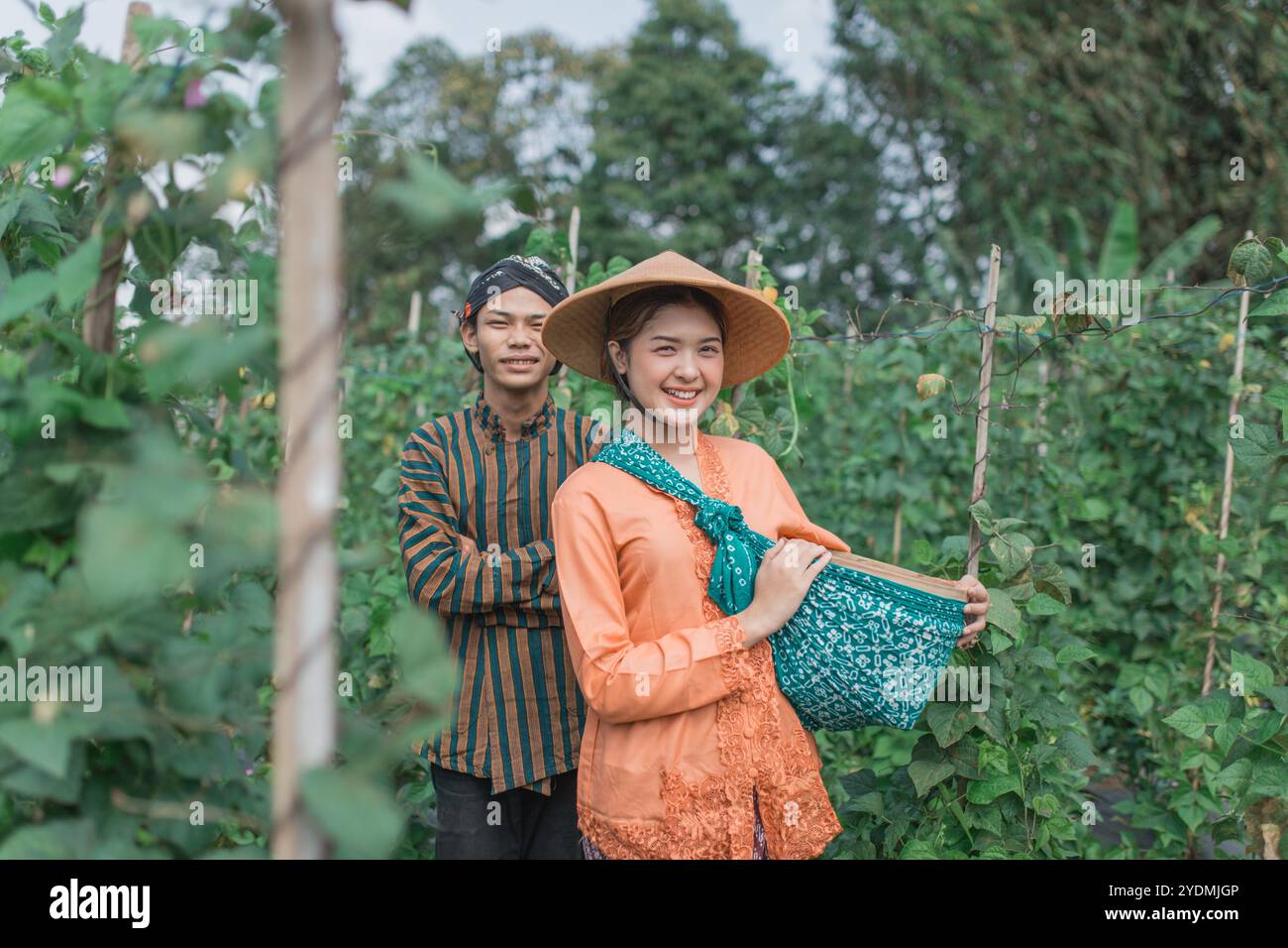 Farmers joyfully celebrating in a vibrant green garden, honoring their ...
