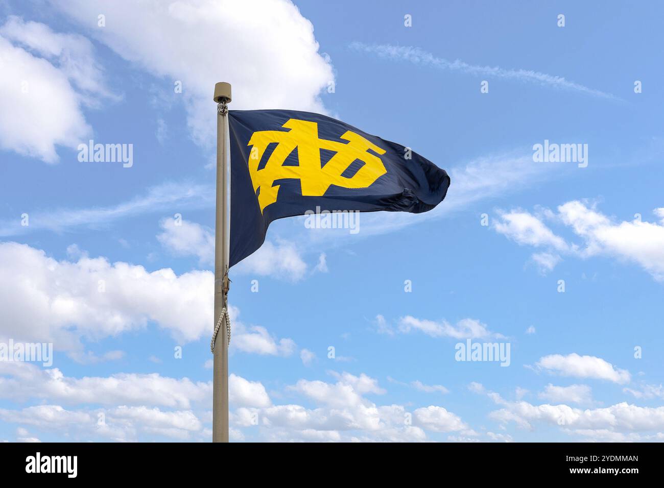 A blue and yellow University of Notre Dame flag flying on top of the ...