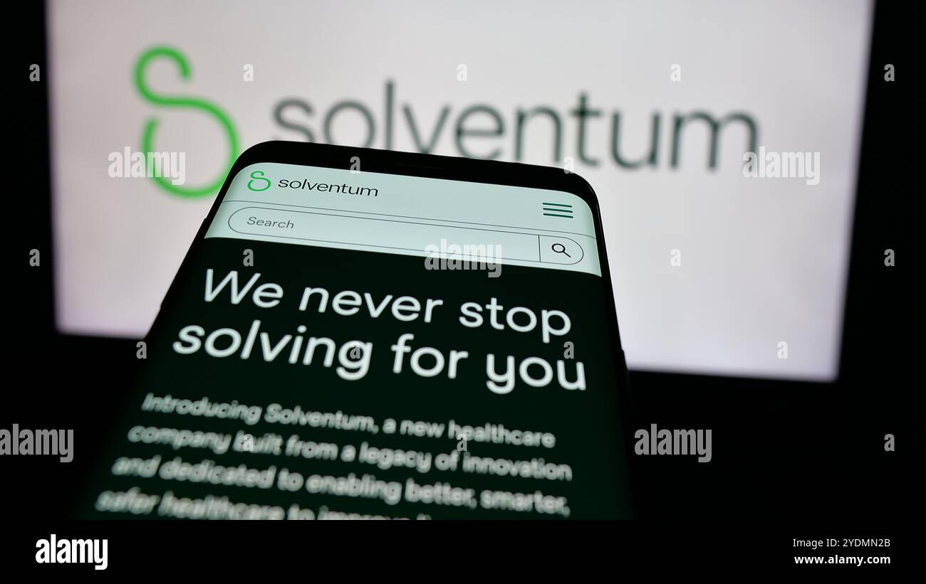 Mobile phone with website of US healthcare company Solventum Corporation on screen in front of ...