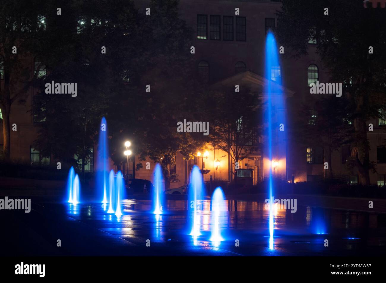 A water fountain show with lights in a park in old quebec city at night ...
