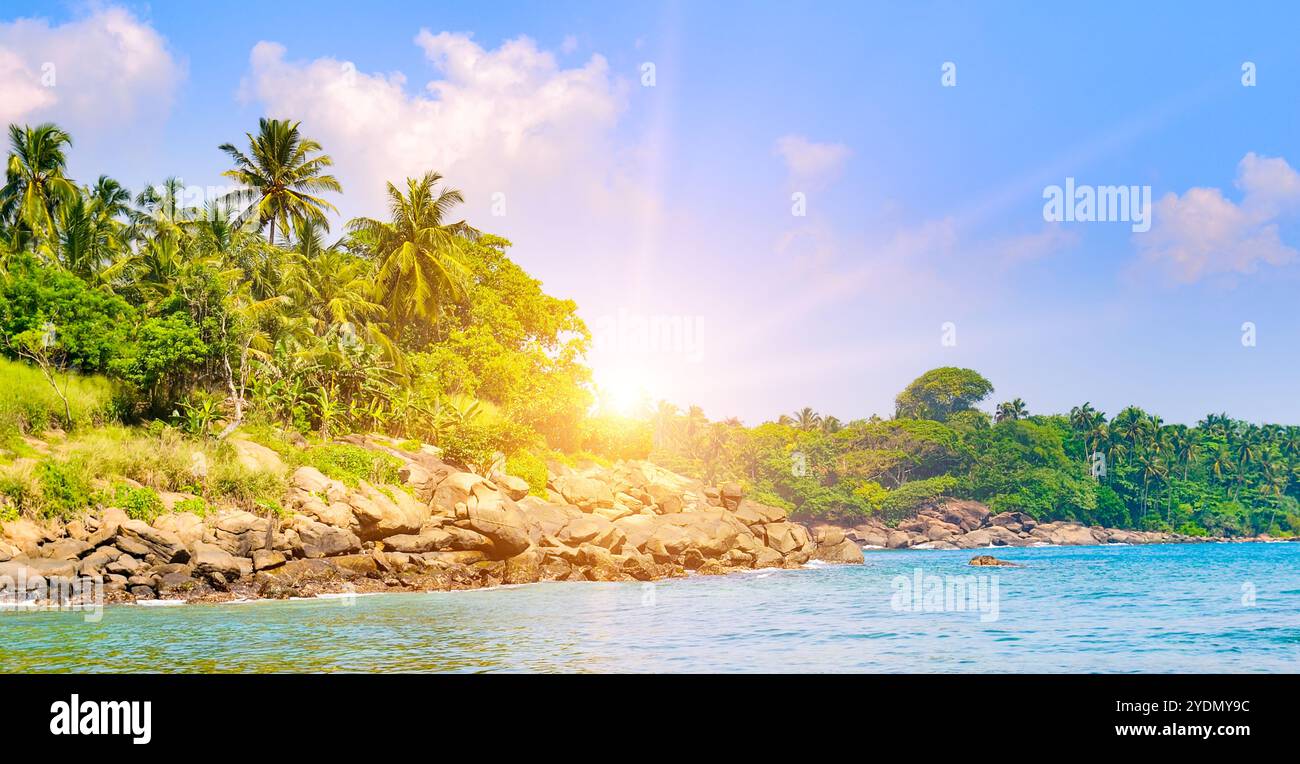 Scenic tropical beach and bright sunrise. Wide photo Stock Photo - Alamy
