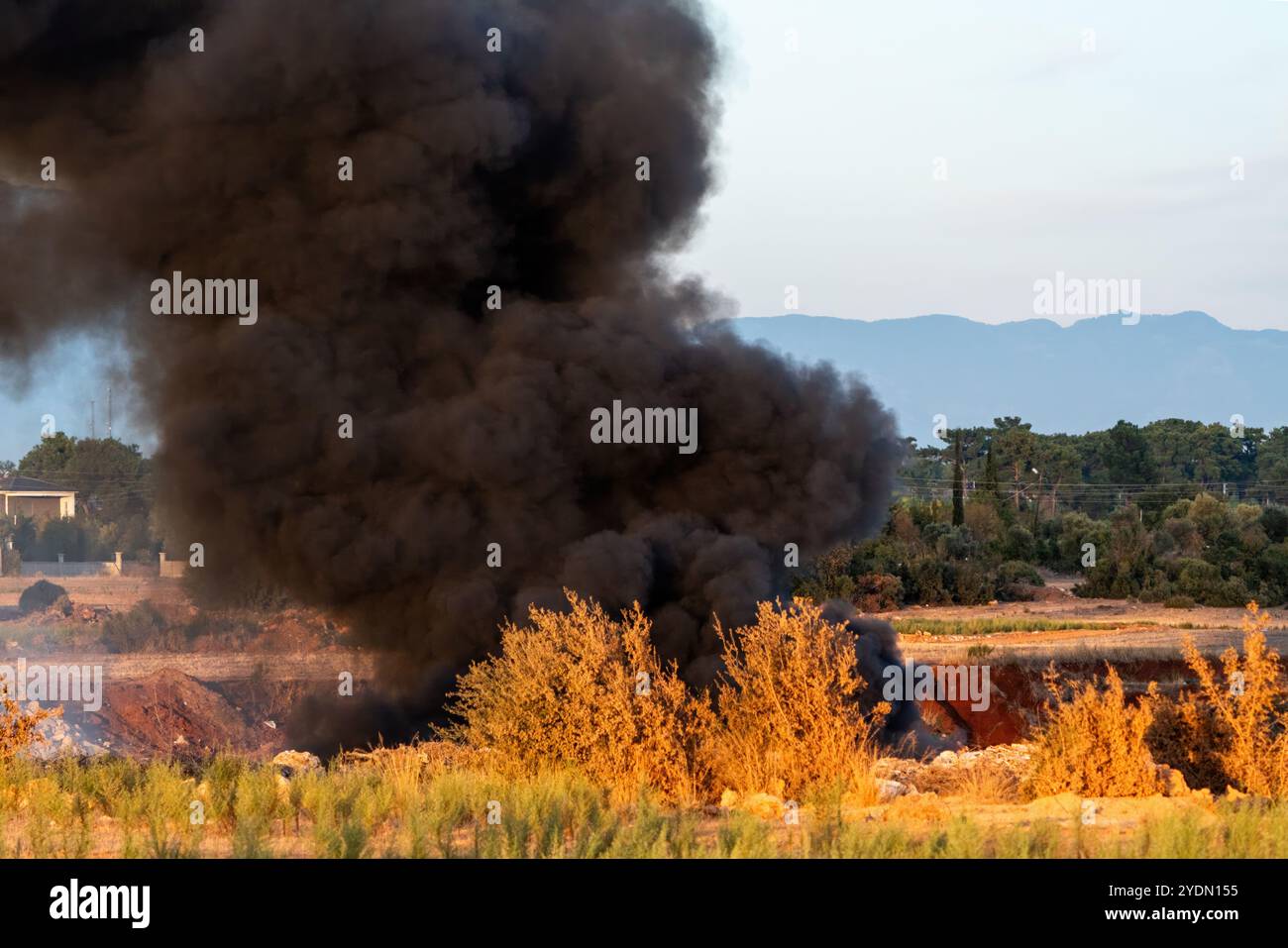 A fire in a garbage dump. Dumpster fire Stock Photo - Alamy