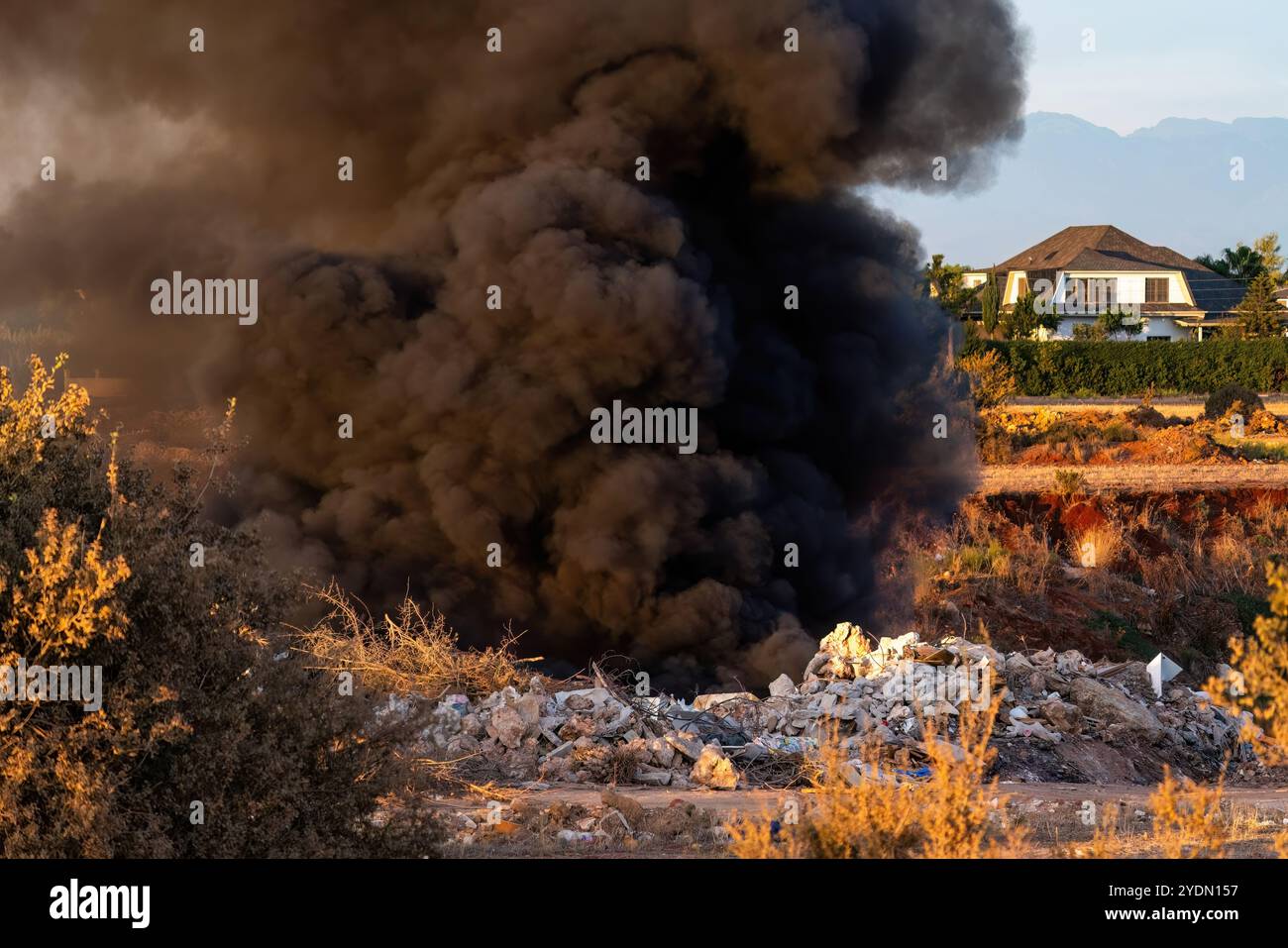 A fire in a garbage dump. Dumpster fire Stock Photo - Alamy