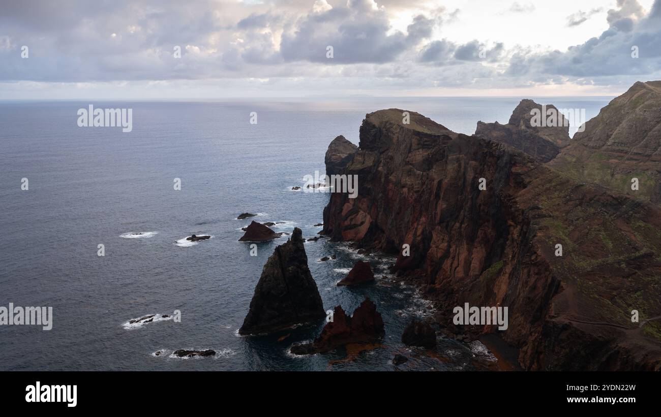 Landscape shot of steep high cliffs and sea stacks with rough Atlantic ...