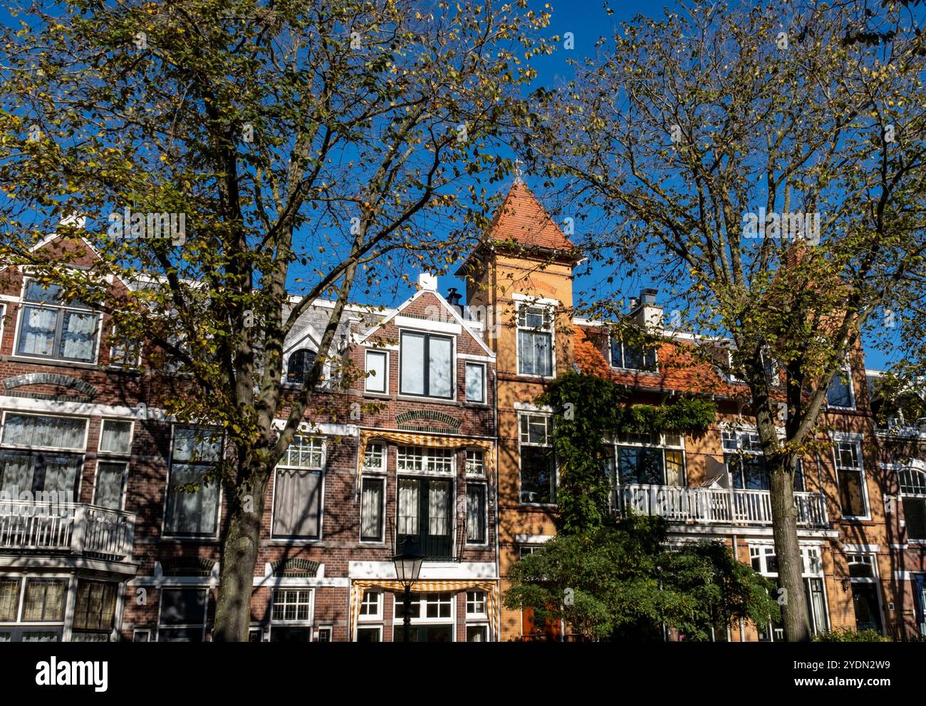 Typical Dutch cityscape on the sunny day with streets, a calm canal ...