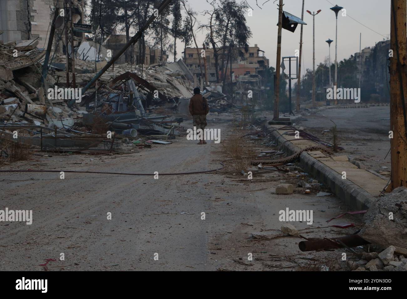 Free Army fighters walk around among the buildings destroyed in the ...