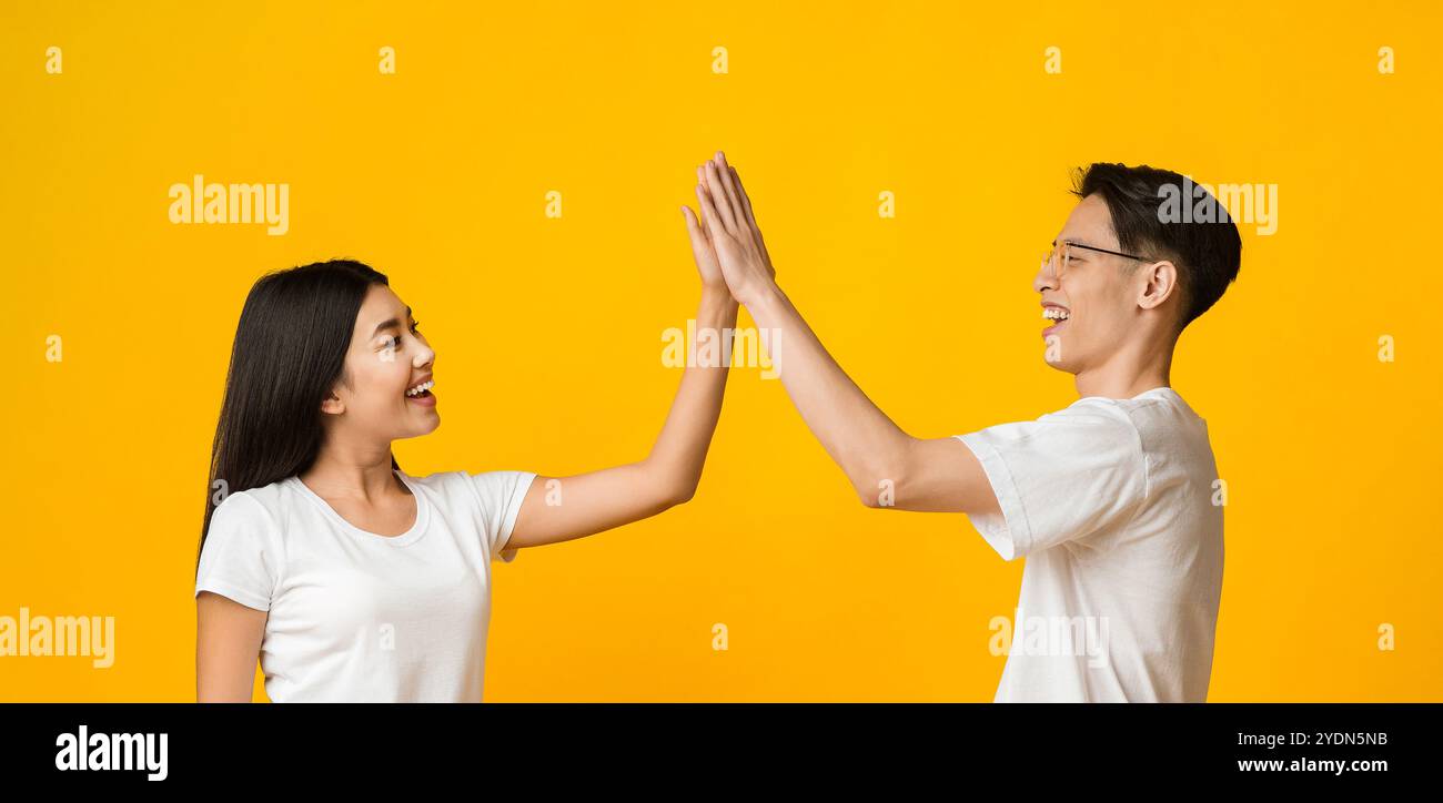 Happy asian man and woman clapping their hands Stock Photo - Alamy