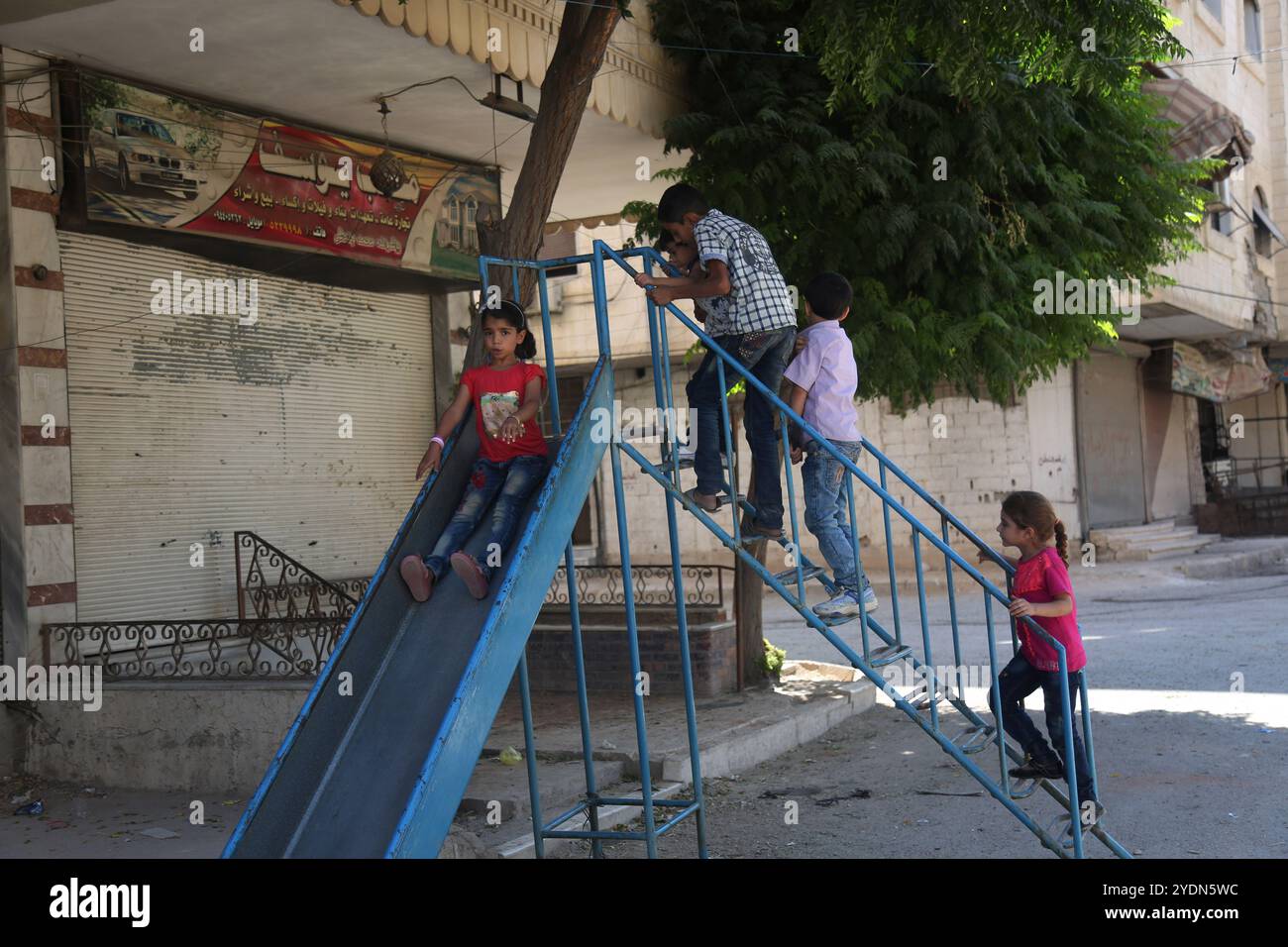 Syrian children playing during Eid al-Adha in spite of the war Stock ...
