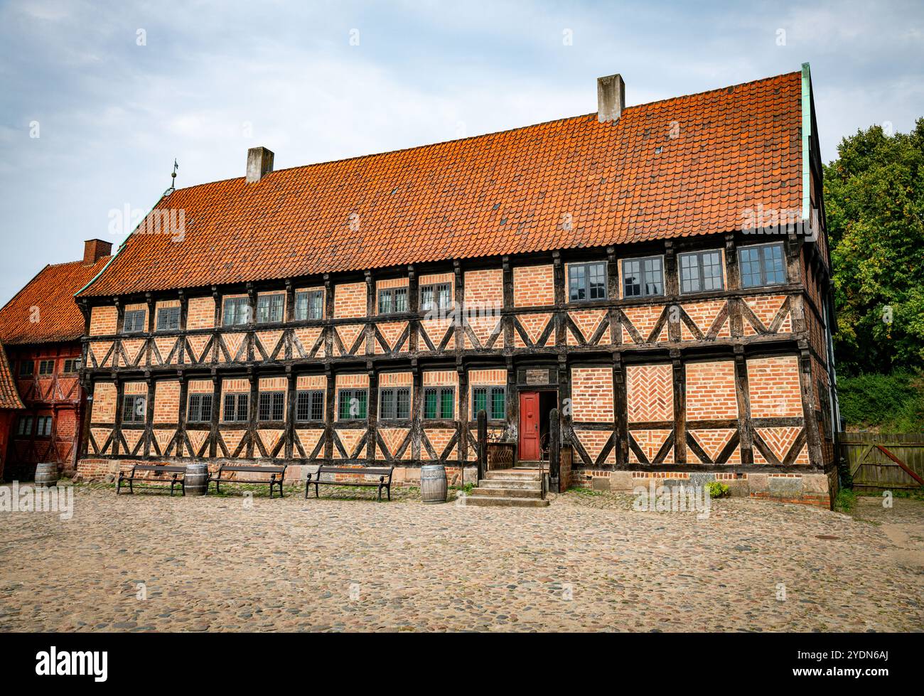 historic Timber-Framed Building with Red Roof and Cobblestone Path ...