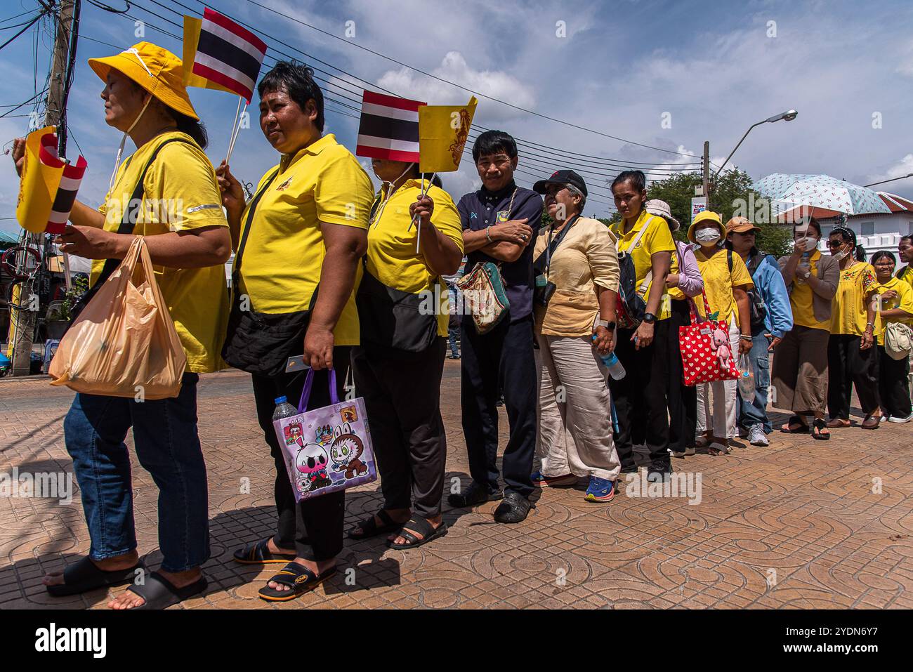 Spectators queue to watch the royal barge down the Chao Phraya River ...