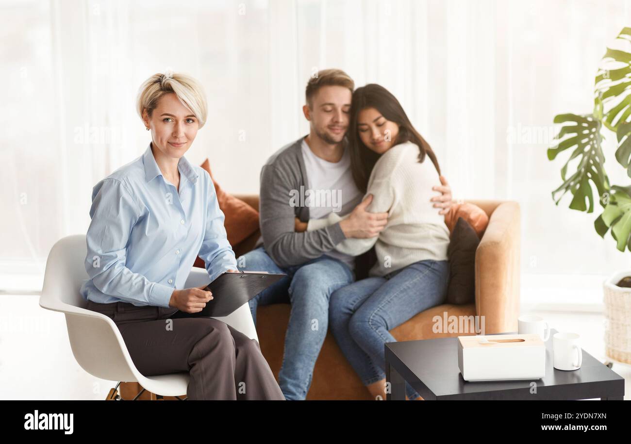 Professional Family Psychologist Sitting Next To Couple After Therapy ...