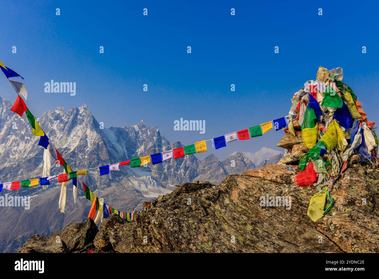 Colorful prayer flags with mantra written on it in the Himalayas ...