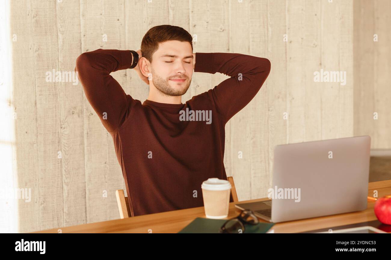 Relaxed Office Worker Sitting Holding Hands Behind Head At Workplace ...