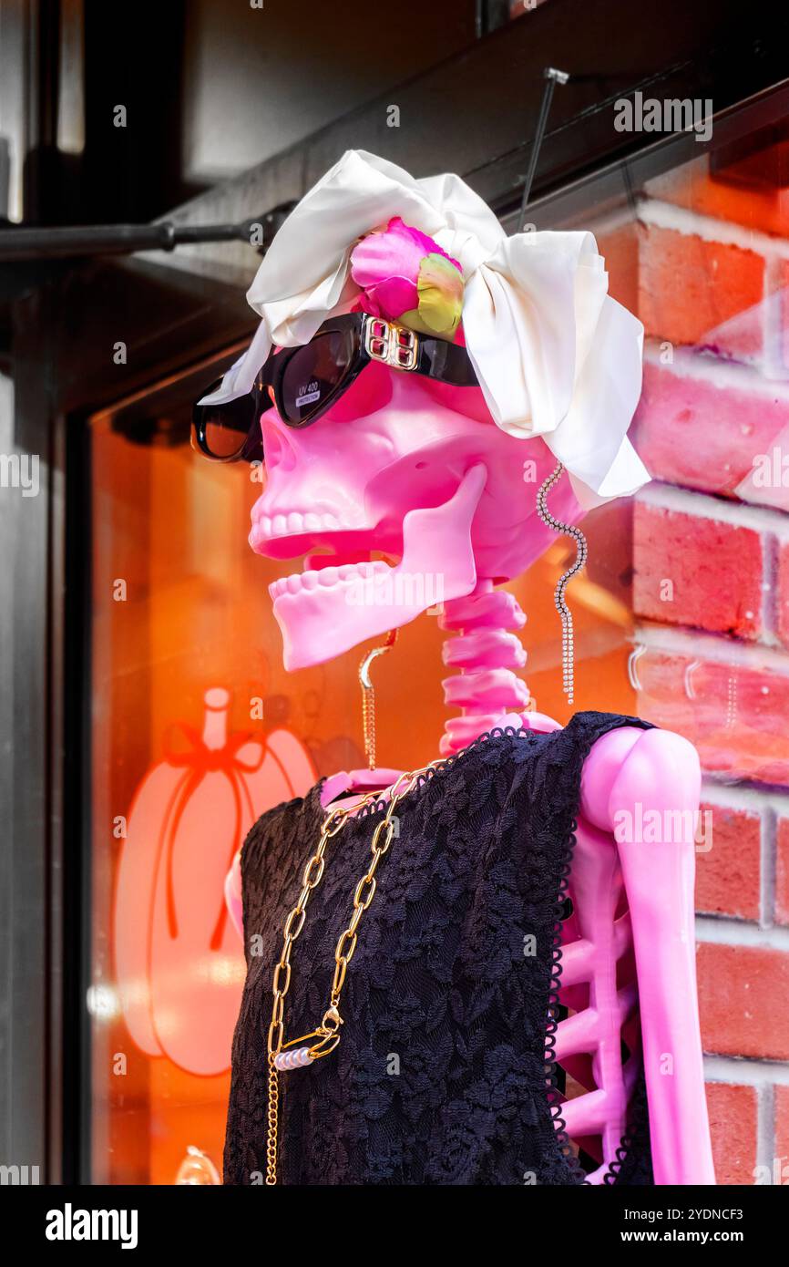A pink mannequin skeleton wearing stylish black sunglasses and a ...