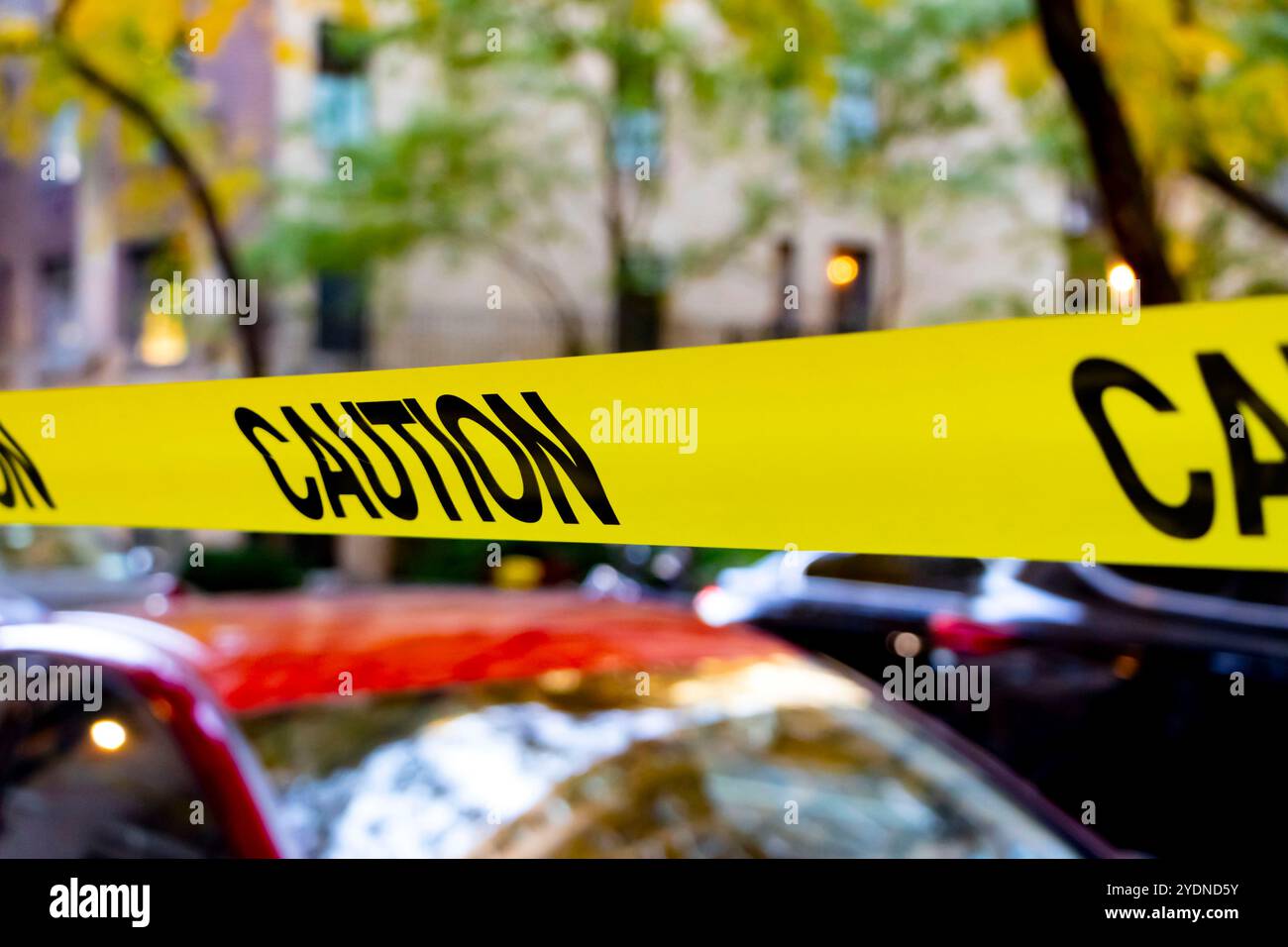 Yellow caution tape stretched across a street in new york city usa with ...