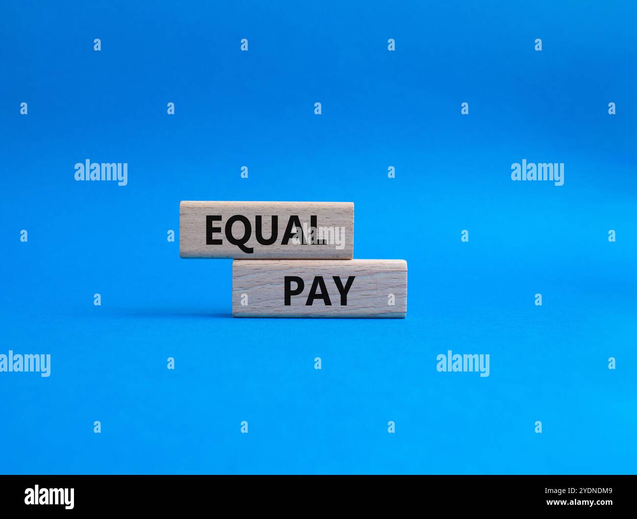 Equal Pay symbol. Wooden blocks with words Equal Pay. Beautiful blue ...